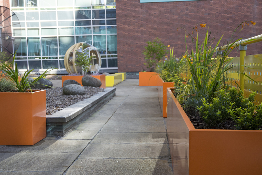 Custom coloured steel planters, University of Manchester | IOTA | ESI ...