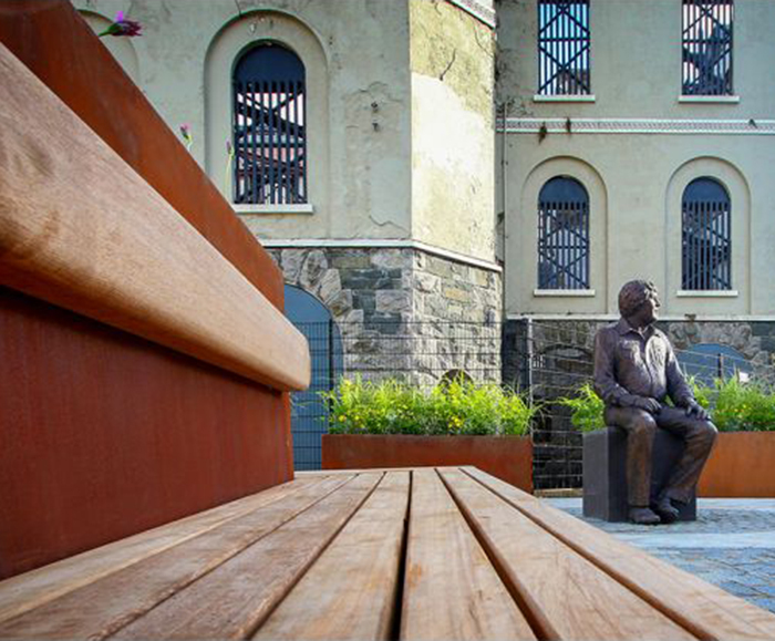 Corten steel planters with seating for public realm area | IOTA | ESI ...