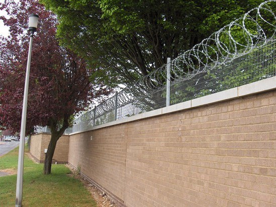 Barbed tape and wire wall / fence / gate topping | Jacksons Fencing ...