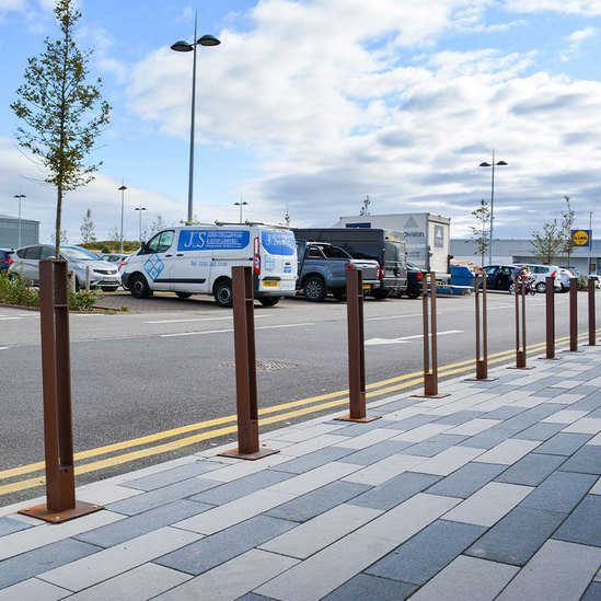 Corten steel bollards and cycle stands for retail park | Artform Urban ...