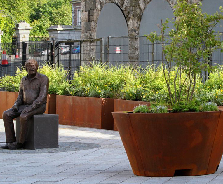 Corten steel planters with seating for public realm area | IOTA | ESI ...
