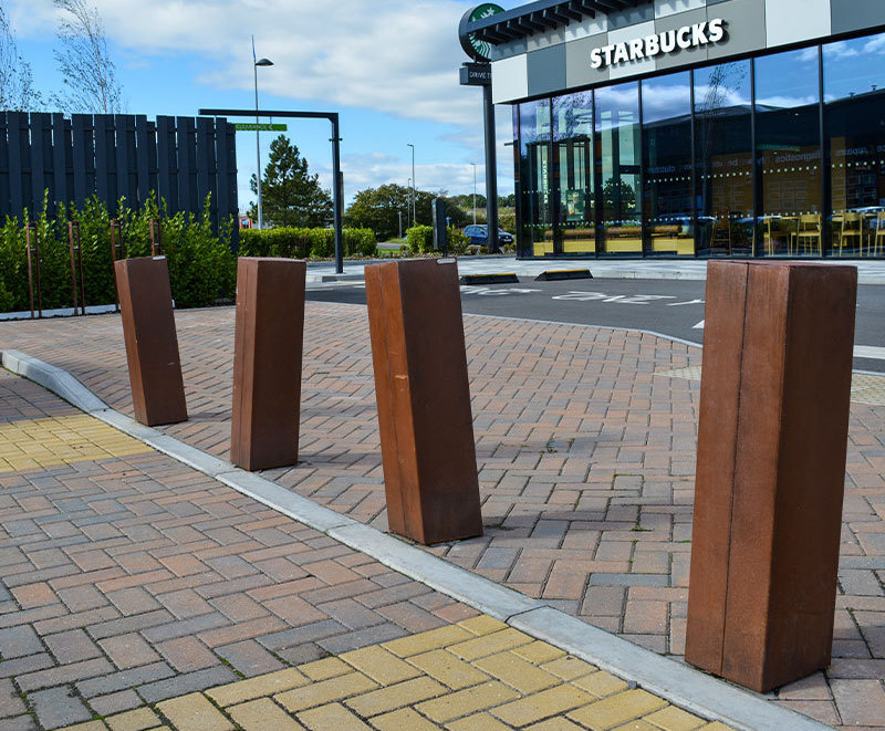 Corten steel bollards and cycle stands for retail park | Artform Urban ...