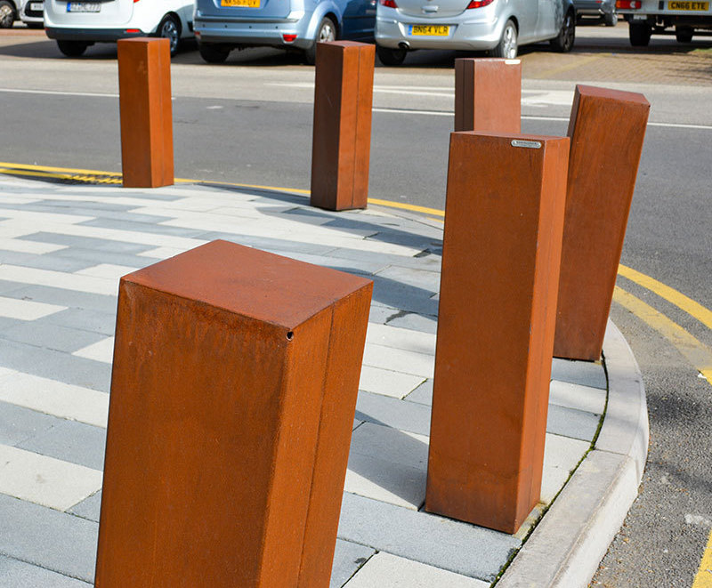 Corten steel bollards and cycle stands for retail park | Artform Urban ...